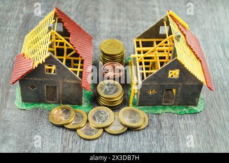 unfinished model houses and Euro coins, symbolising the rise in house ...