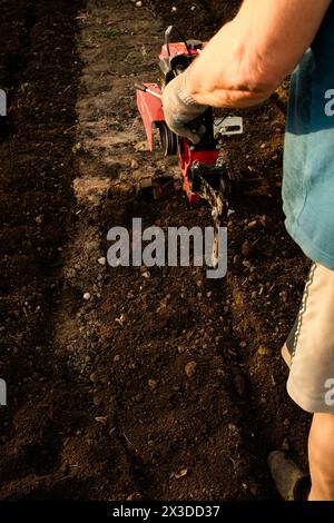 a tillerblock plows the land in the garden. A tillerblock for plowing ...