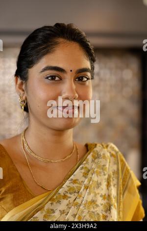 Young woman wearing bindi and traditional kurta dress smiling with ...