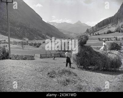 1950s, historical picture of a farmer with a pitchfork and his wife ...