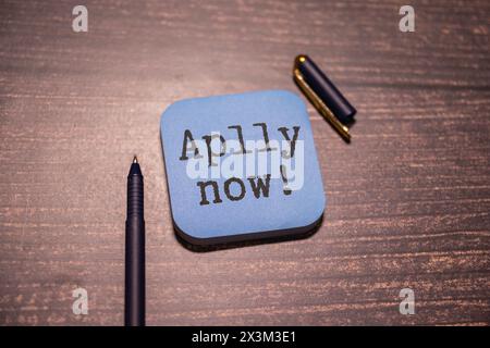 Aplly today text written in notebook on a wooden table. View from above ...