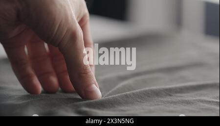 man touching green cotton clothes closeup, wide photo Stock Photo - Alamy