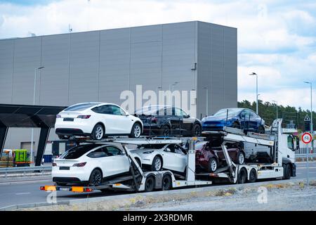 semi-truck transports loaded new Tesla vehicles leaving Gigafactory ...