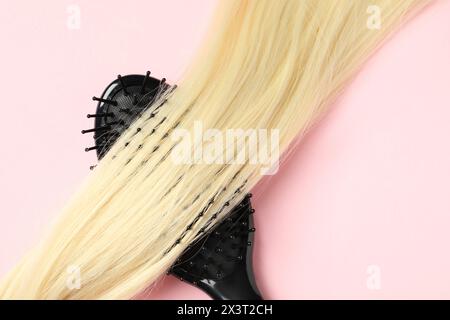 Hair brush with strand on color wooden background Stock Photo - Alamy