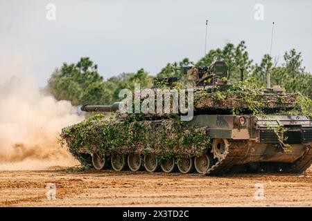 An Abrams tank fires on a simulated enemy position on Red Cloud Range ...