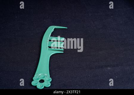 close up of a broken toothed comb on a black background with empty ...