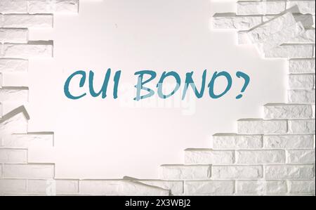 CUI BONO (to whose benefit) question on a note made of paper on a blue ...