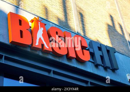 Basic-Fit sign at fitness club. Basic-Fit is the European market leader ...