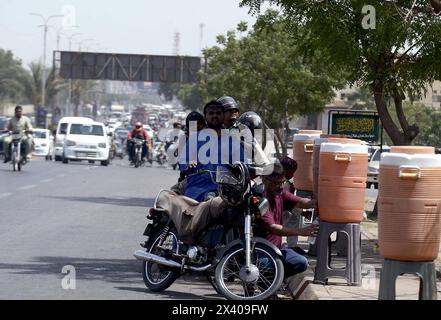 Commuters are drinking chilled water to beat the heat of sun at a camp ...