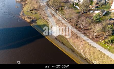 Drone photography of flooded riverside bank in a city during spring ...