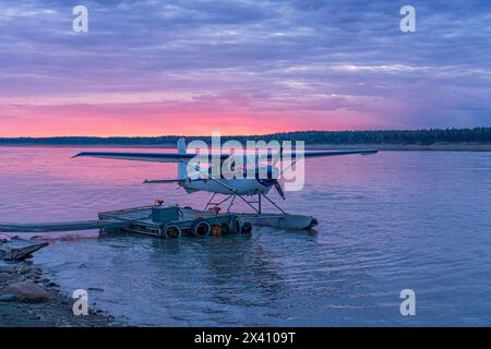 Floatplane in the Mackenzie River as the setting sun lights up the ...