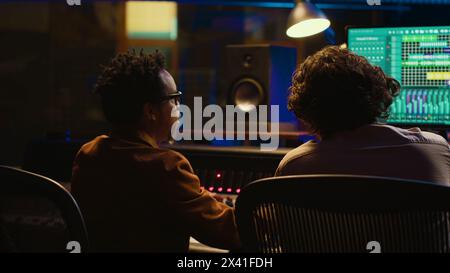 Audio expert and musician mixing and mastering tracks on control room ...