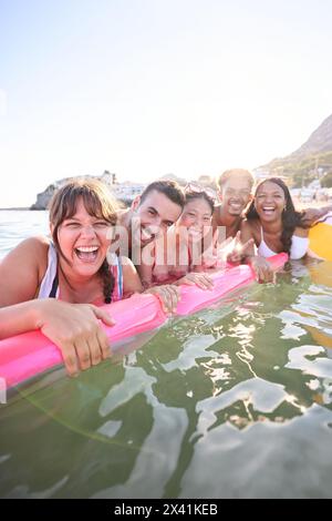 Portrait of cheerful females and males having fun in the bar Stock ...