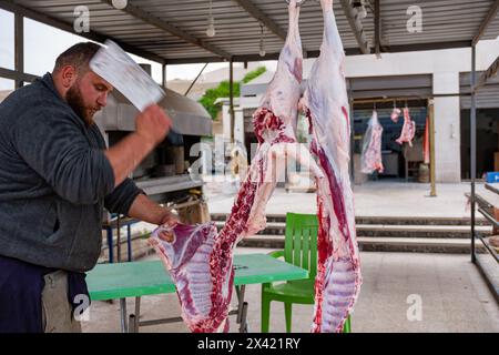 Bearded man cutting meat for poor peoples during eid in butchery Stock ...