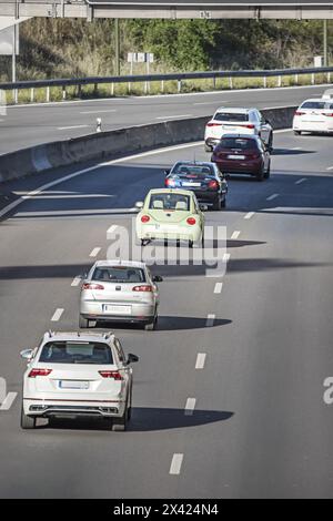 a line of utility vehicles traveling on a highway with several lanes in ...