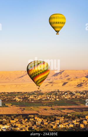 EDITORIAL USE ONLY A hot air balloon is suspended over Potters Fields ...