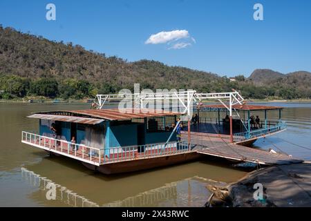 A Laotian ferry boat carries motorcycles, scooters, assorted vehicles ...