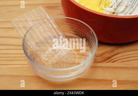 Stacked leaves of gelatine (isinglass) in black bowl Stock Photo - Alamy