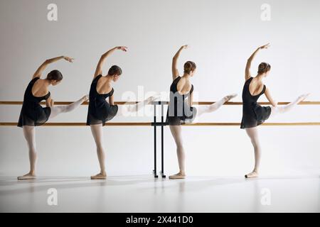 Four ballet dancers, teen girls in black leotards dancing against grey studio background ...