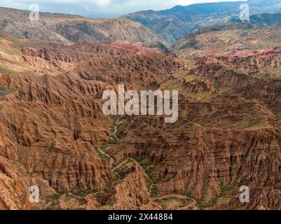Badlands, river in a gorge with eroded red sandstone rocks, Konorchek ...