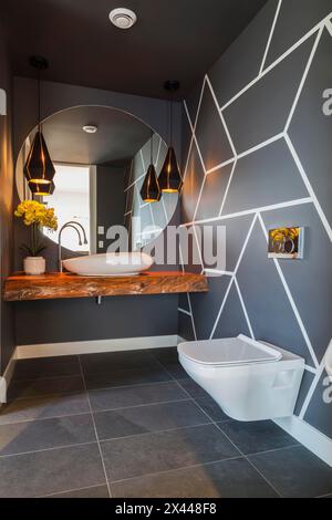 White ceramic sink and mirror with illumination in bathroom designed in ...