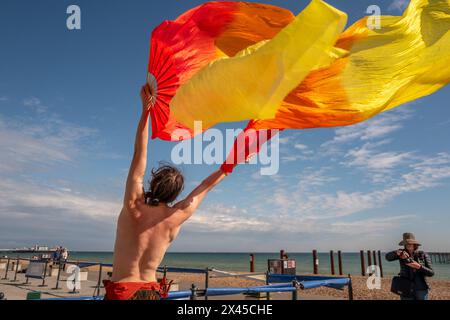 Brighton, April 30th 2024: A young man fan-dancing in the beautiful ...