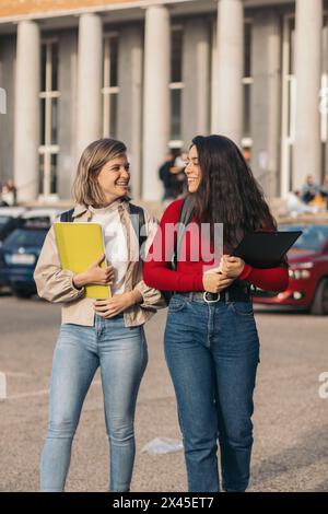 two student girls leaving class Stock Photo - Alamy