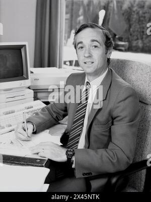 1987, a male business executive at his desk, an accountant, writing out ...