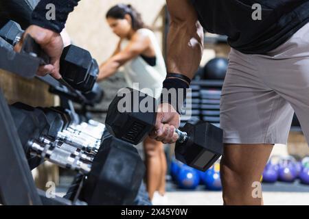 Crop unrecognizable muscular male bodybuilder taking heavy metal ...