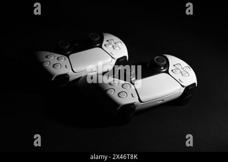 Two wireless game controllers on orange background Stock Photo - Alamy