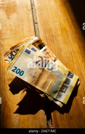 Euro banknotes in fan at wooden textured background Stock Photo - Alamy