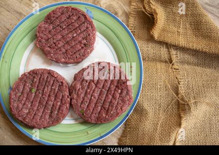 raw beef hamburger ready to be cooked in a dish Stock Photo - Alamy