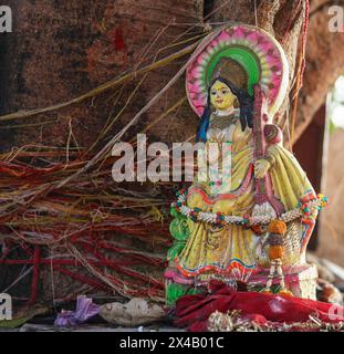 Shrine in Varanasi, India with a goddess icon, a statue of Hanuman and ...
