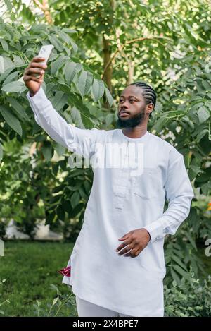 Young urban man with smarphone outdoors on background of St Basils ...