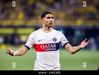 Achraf Hakimi of Paris Saint-Germain kisses the trophy after the Paris ...