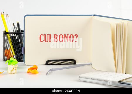 CUI BONO (to whose benefit) question on a note made of paper on a blue ...