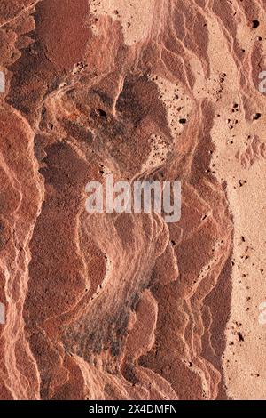 A section of ancient sandstone sediment showing eroded layers in a ...