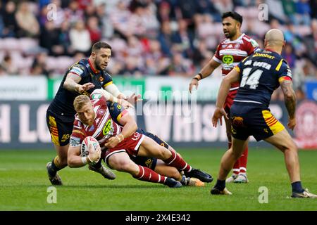 Luke Thompson of Wigan Warriors is tackled during the Betfred Super ...