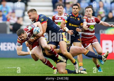 Wigan Warriors' Jake Wardle is tackled by Hull FC's Zak Hardaker during ...