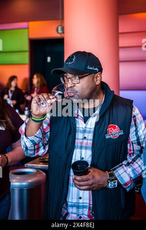 USA, Washington State, Walla Walla. Man samples Cabernet Sauvignon at ...