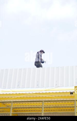 Man on top of tall building in London Stock Photo - Alamy
