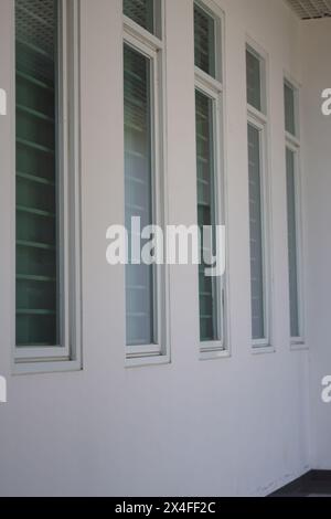 Minimalist white house with windows and blinds. Clean lines ...