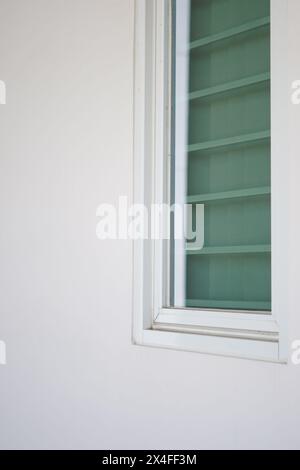 Minimalist background of a long glass window with green curtains and ...