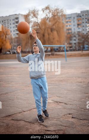 One young person playing basketball Stock Photo - Alamy