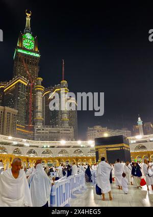 The Holy Kaaba. Crowd of people walking around Kaaba. Tawaf part during ...