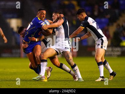 Warrington Wolves' Paul Vaughan (centre) in action with the ball during ...