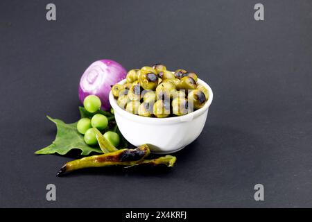 Boiled tiny Wild Eggplant eggplant on white bolw with onion and chili ...