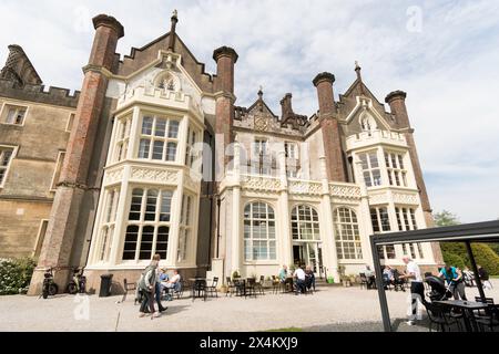 Visitors sitting outside the Manjushri Kadampa Meditation Centre ...