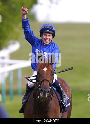 Jockey William Buick (centre) celebrates after winning the QIPCO 2000 ...