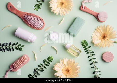 Bath accessories with flowers on green background Stock Photo - Alamy